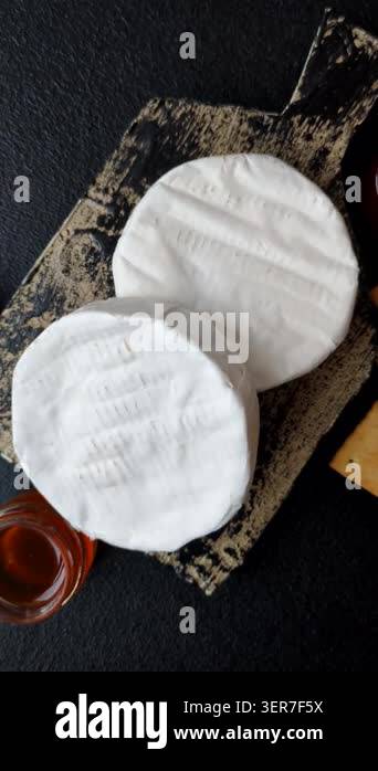 Brie or Camembert cheese is a white, round shape for baking and melting ...