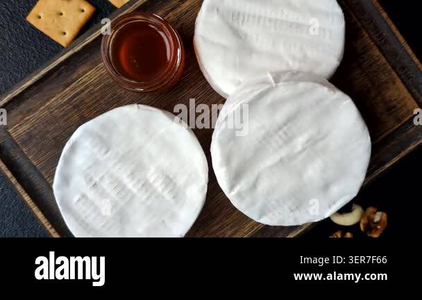 Brie or Camembert cheese is a white, round shape for baking and melting ...
