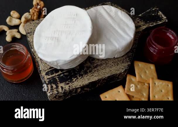 Brie or Camembert cheese is a white, round shape for baking and melting ...