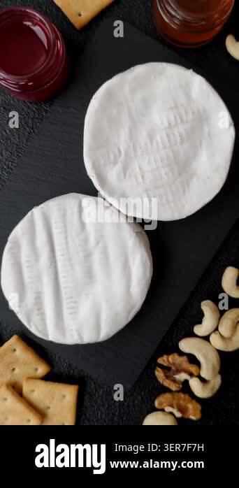 Brie or Camembert cheese is a white, round shape for baking and melting ...