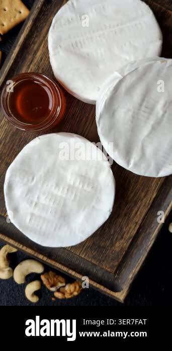 Brie or Camembert cheese is a white, round shape for baking and melting ...