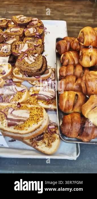 Open-faced sandwiches with salo and mustard sit beside golden brown ...