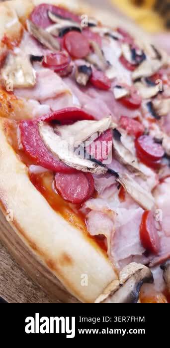 Freshly baked homemade pizza topped with savory ham, melted cheese ...