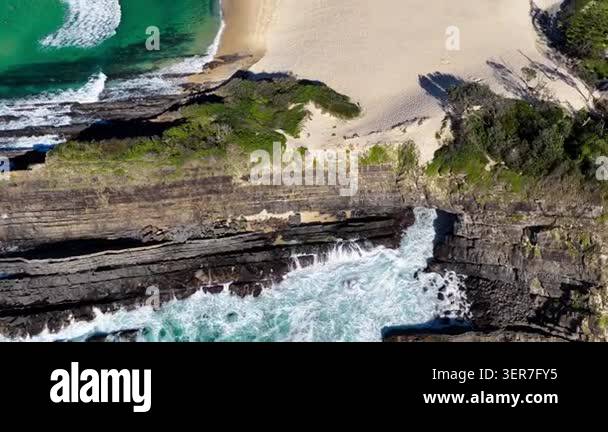 Aerial video flying over Bennetts Headland and its prominent sand dune ...