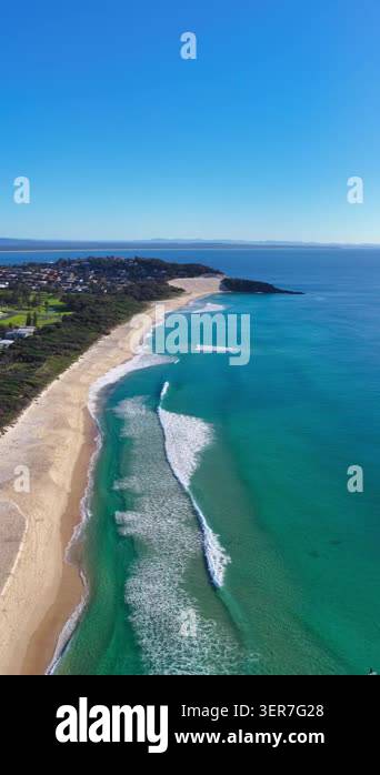 Aerial vertical video panning around One Mile Beach near Forster, NSW ...