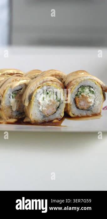 Close-up of fresh Japanese uramaki sushi rolls with unagi, tempura ...