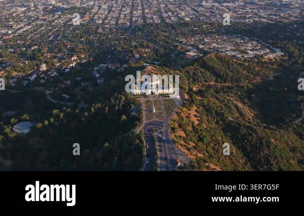 Golden hour light casting long shadows over Griffith Observatory and ...