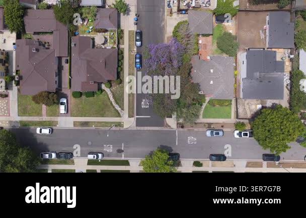 Top down aerial shot of a residential neighborhood with houses, cars ...