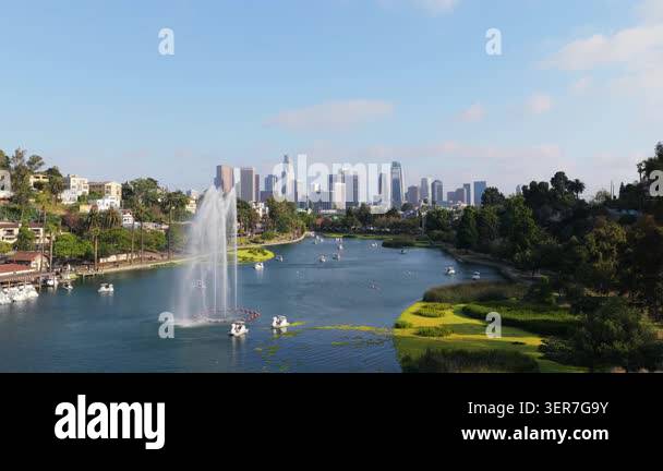 Scenic aerial of Echo Park Lake revealing downtown Los Angeles skyline ...