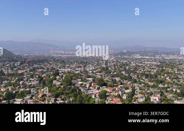 Scenic flight over Hollywood Hills with a wide panoramic expanse of Los ...