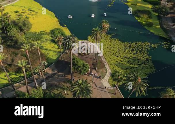 Echo Park Lake ascending shot showing fountain, palm trees, Downtown ...