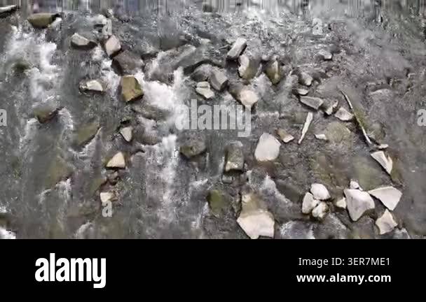 Aerial view of a mountain river with flowing water over rocks ...