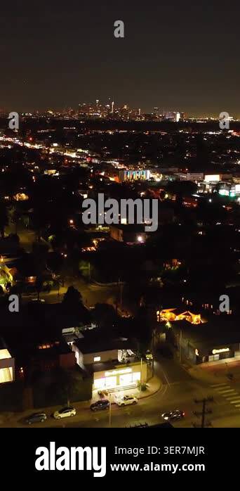 Aerial footage of night city. Houses in residential urban district and ...