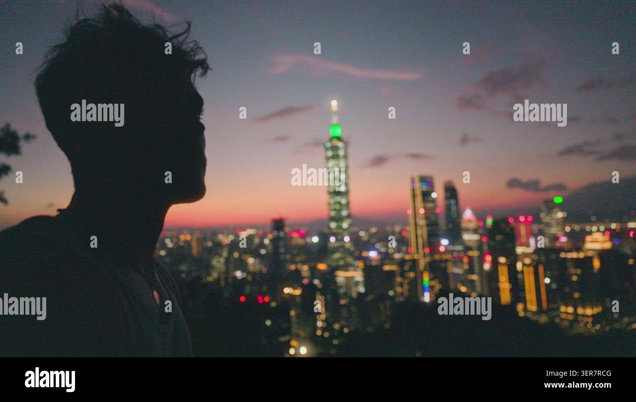 Man in silhouette watching the city lights of Taipei Stock Video ...
