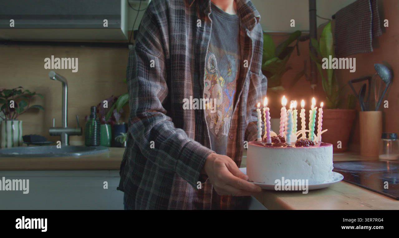 Person carrying birthday cake with lit candles to family party Stock ...