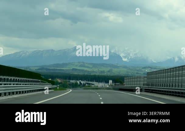 Multi-lane motorway with sound barriers leading toward the High Tatras ...