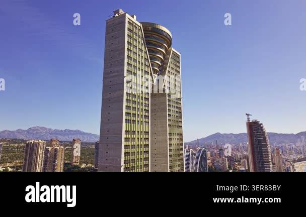Modern skyscraper architecture with unique design against clear blue ...