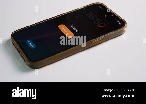Smartphone timer reaches zero and alarm activates on the screen resting ...