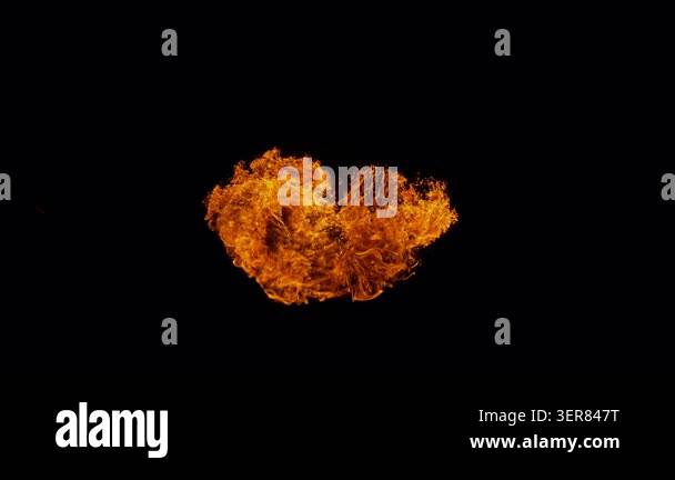 Small fire explosion with glowing sparks and embers isolated on a black ...
