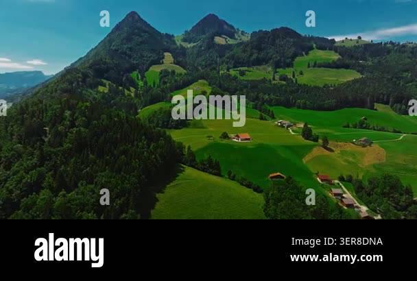 Establishing shot of Switzerland. Aerial view of the green meadows of ...