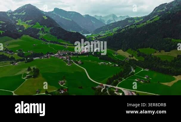 Establishing shot of Switzerland. Aerial view of the green meadows of ...