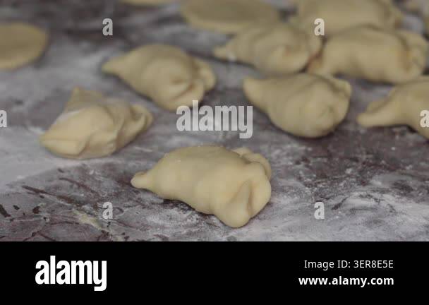 Close-up of fresh homemade pierogi dumplings being prepared on a ...