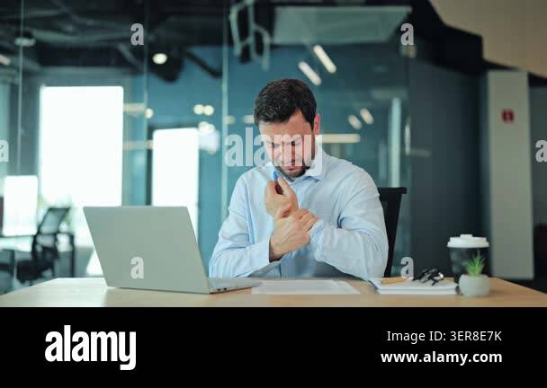 Overworked businessman or IT specialist feeling hand pain, carpal ...
