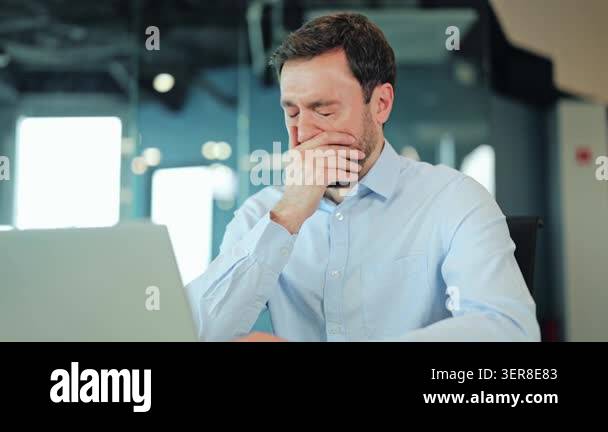 Close-up of lazy corporate worker or IT specialist leaning chin on palm ...