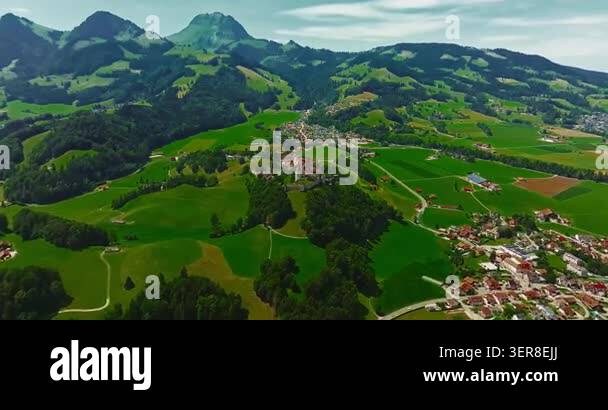 Establishing shot of Switzerland. Aerial view of the green meadows of ...