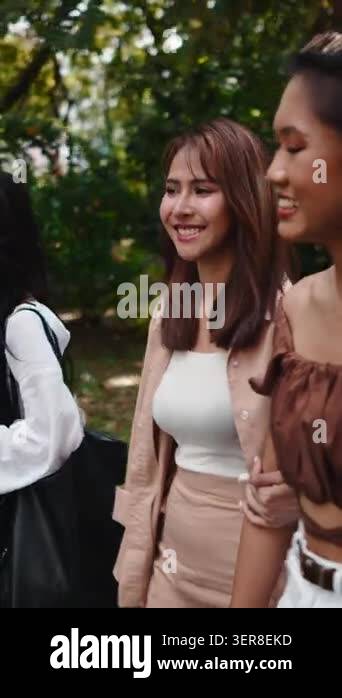 Group of happy young asian friends having fun, chatting and walking ...