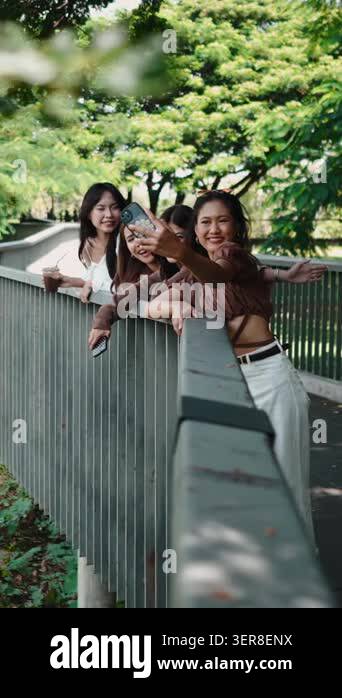 Happy group of female friends taking a selfie video with a smartphone ...
