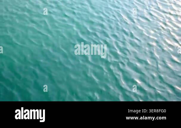 Beautiful close up of blue ocean water rippling under the sunlight ...