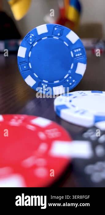 Colorful poker chips on casino table with blurred background lights ...