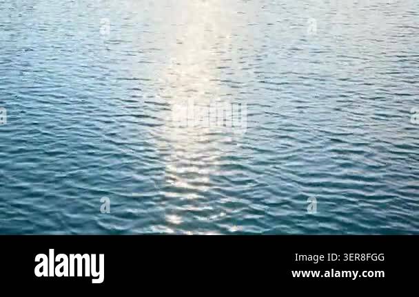 Beautiful close up of blue ocean water rippling under the sunlight ...