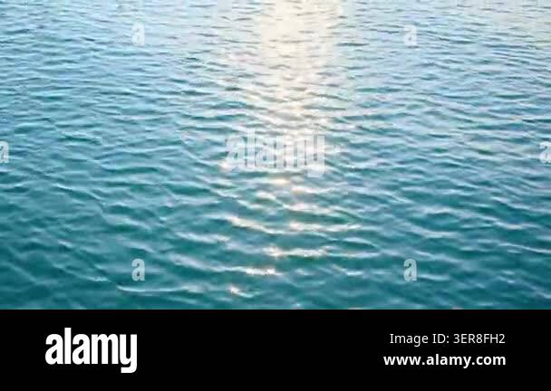Beautiful close up of blue ocean water rippling under the sunlight ...