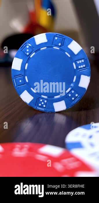 Colorful poker chips on casino table with blurred background lights ...