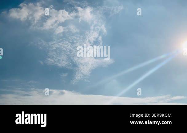 Bright sun with lens flare and wispy clouds over Jakarta, Indonesia ...
