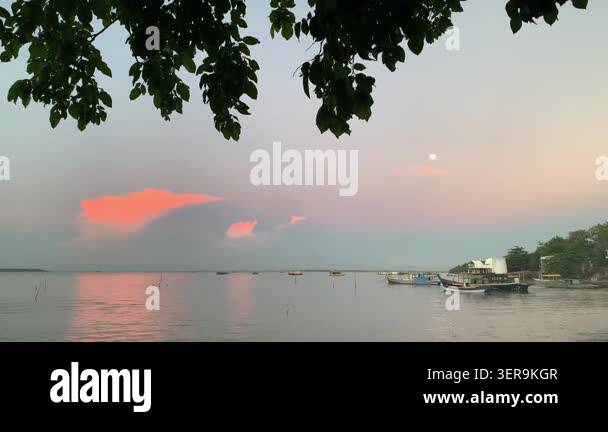 4K sunset seascape with fishing boats and glowing clouds at Tanjung ...
