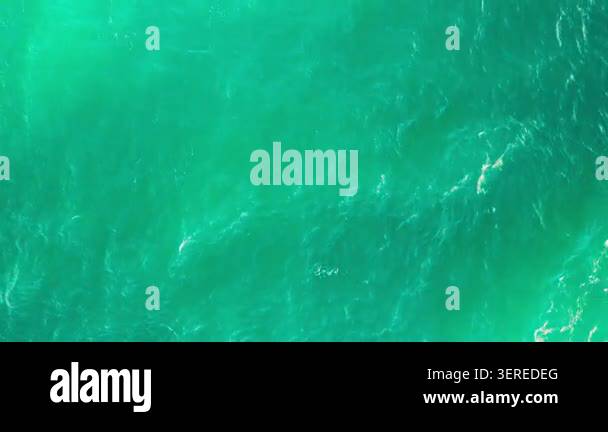 Aerial drone footage shot directly overhead of clear turquoise ocean ...