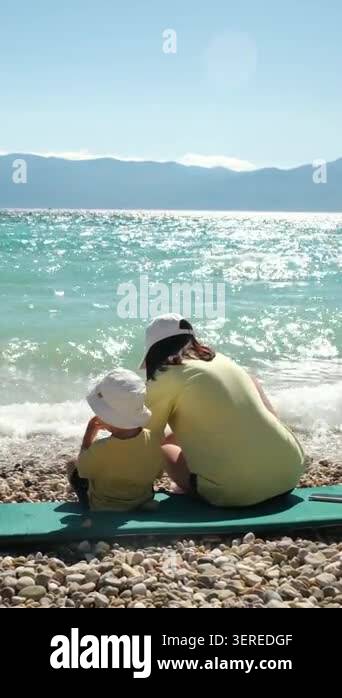 Mother and child sitting by the sea Croatia krk Stock Video Footage - Alamy