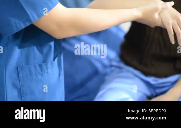 doctor examining patient in hospital ward Stock Video Footage - Alamy