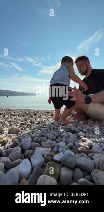 Father and toddler on a rocky beach by the sea croatia krk Stock Video ...