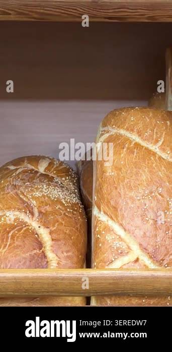 Soft white bread arranged on store shelves with fresh bakery atmosphere ...