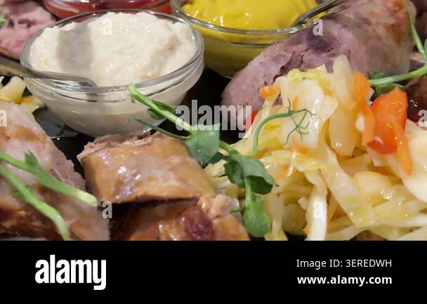 Traditional meat assortment with sliced sausage tender meat sauerkraut ...