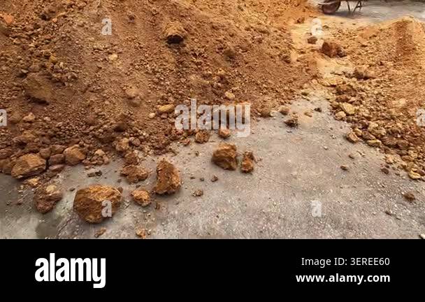 Pile of excavated soil on a construction site with rough earth texture ...