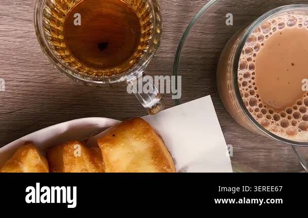 Top view of hot tea in a glass cup on a wooden table. Cozy beverage ...