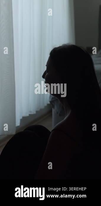 Broken hearted woman sitting alone in dark room after breakup. High ...