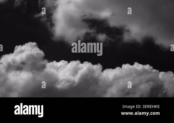 Time-lapse of Soft white cloud masses shifting quickly against a black ...