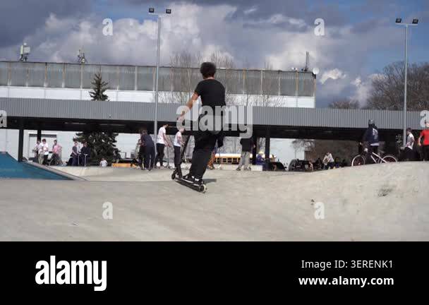 Kids playground. Boy on scooter doing stunts jump. Street sport outdoor ...