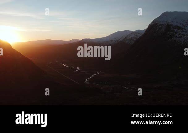 Slow drone footage over mountain valley near Glencoe, Scotland with ...
